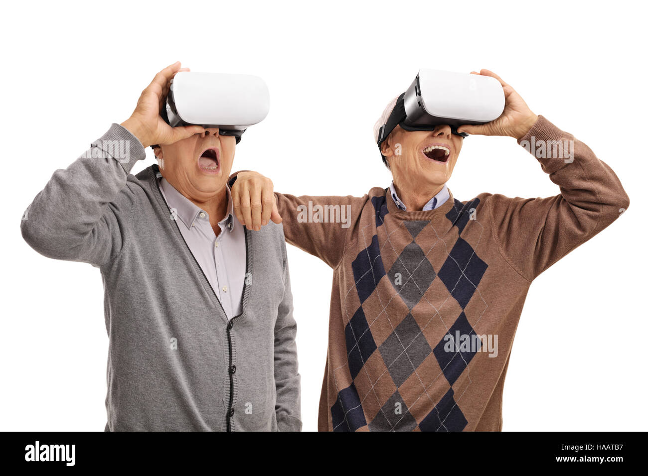 Excited seniors using VR headsets isolated on white background Stock ...