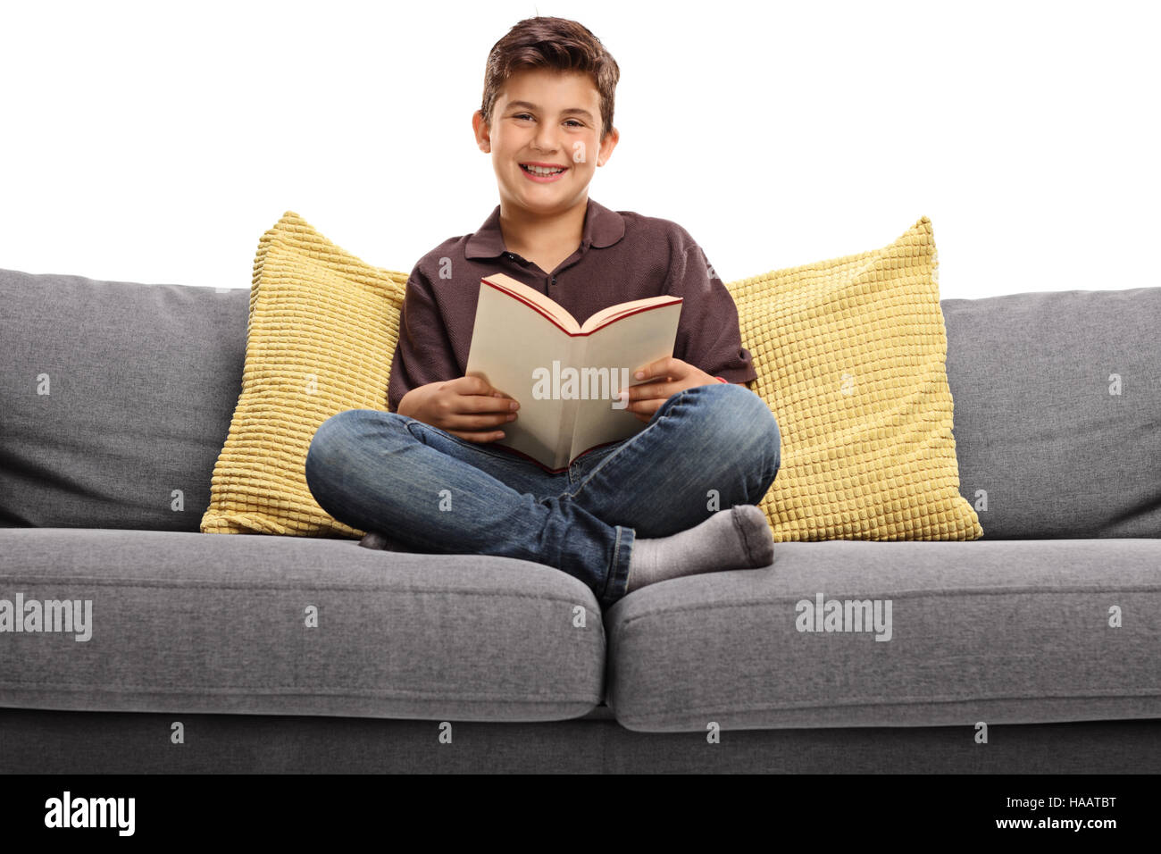 Boy sitting on a sofa reading hi-res stock photography and images - Alamy