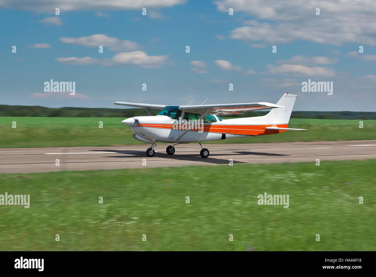 Small light private plane is taking off on a sunny day for a leisure ...