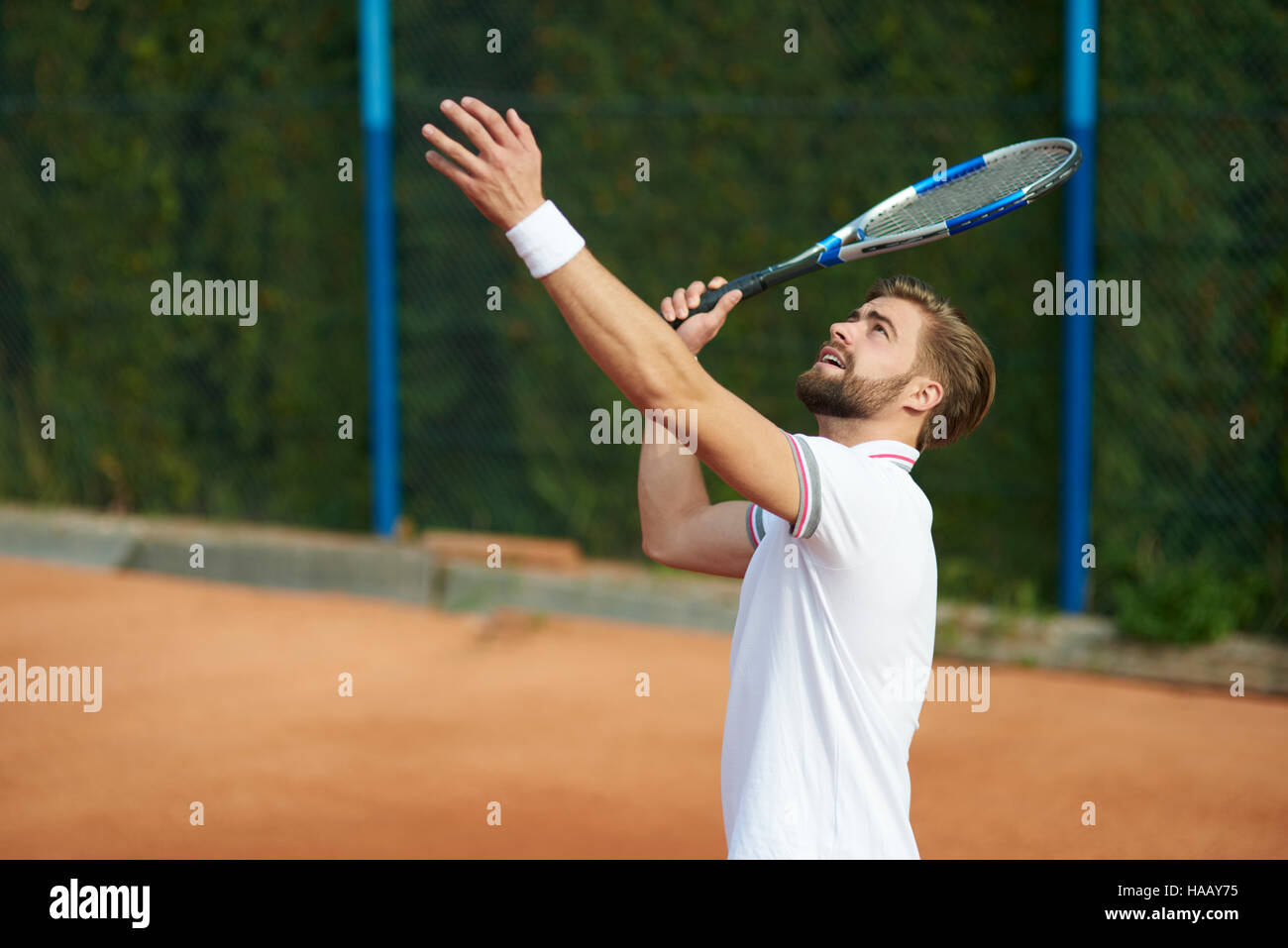 Man about to serve a tennis ball Stock Photo - Alamy