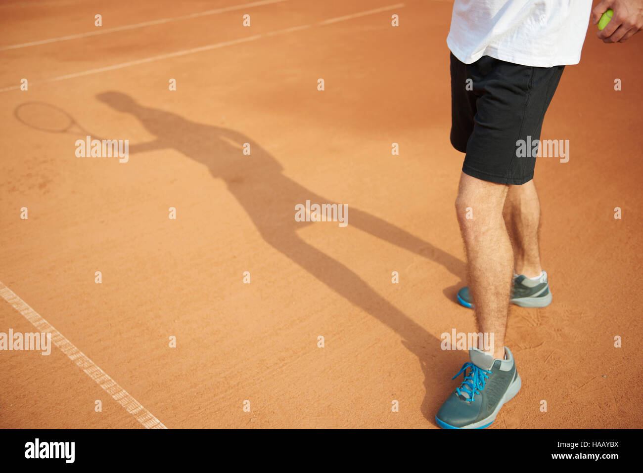 Shadow of the man who's playing the tennis Stock Photo - Alamy