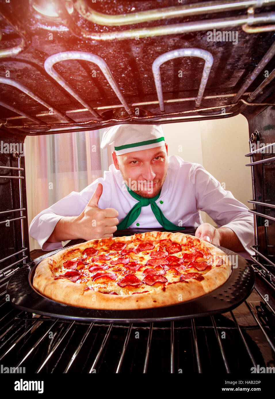 Chef prepares pizza in the oven, view from the inside of the oven ...
