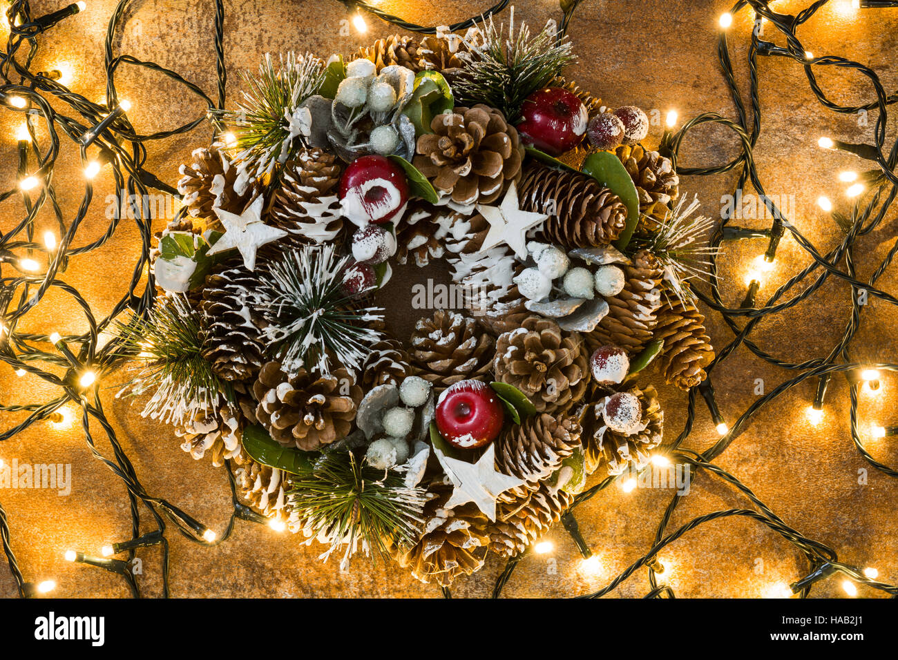 Wreath and Christmas lights on rusty background Stock Photo - Alamy