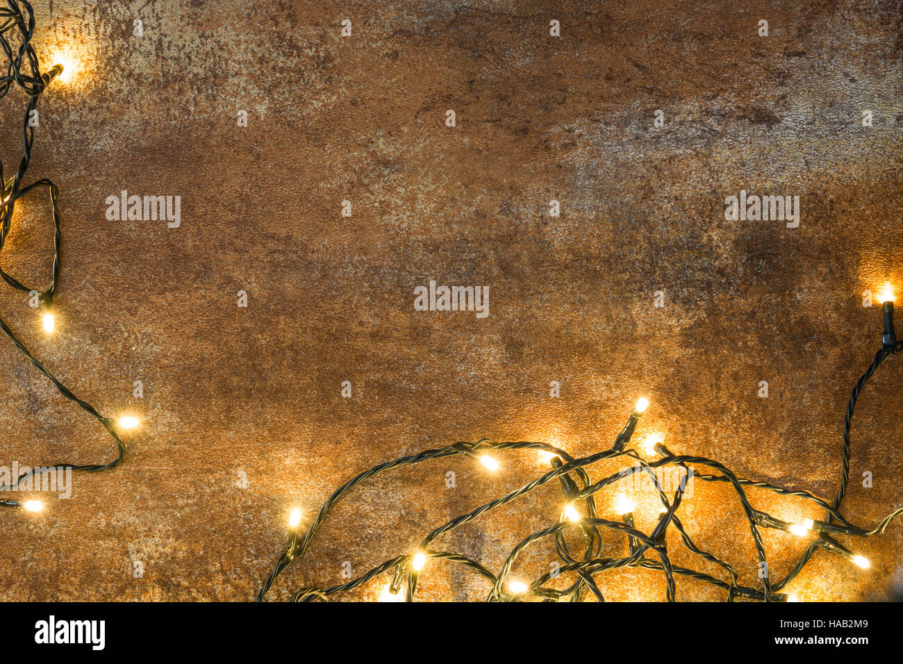 Christmas lights on rusty background Stock Photo - Alamy