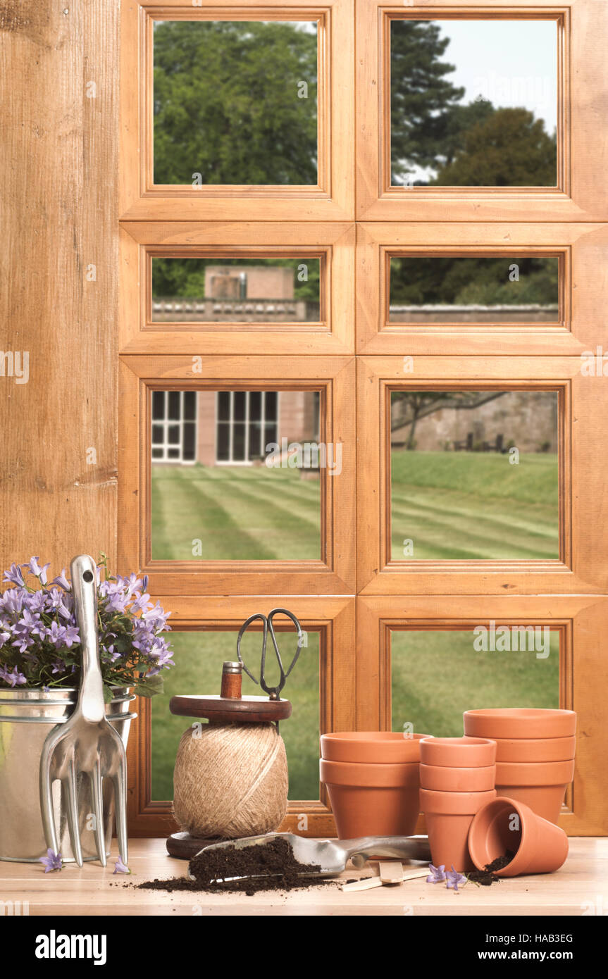 The potting shed with window overlooking garden Stock Photo - Alamy