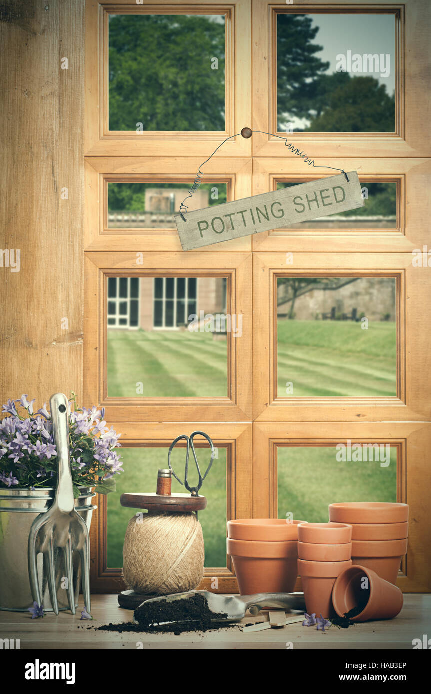 The potting shed with window overlooking garden Stock Photo - Alamy