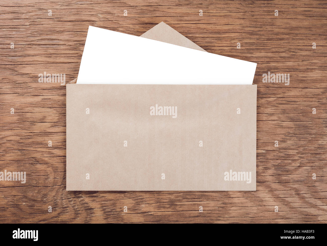 envelope whit blank on wooden table Stock Photo - Alamy