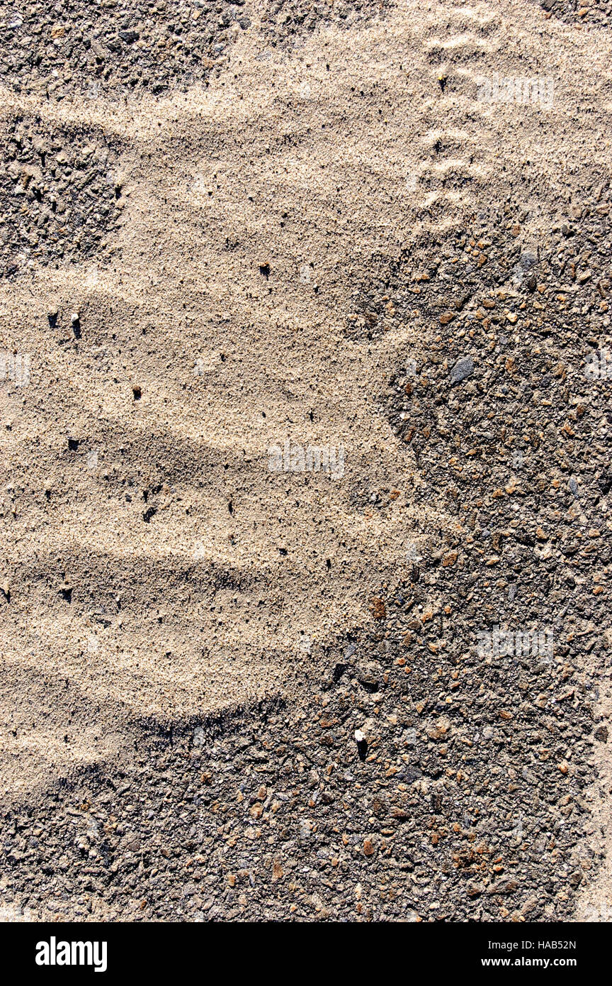 Asphalt road surface with film of thin sand over Stock Photo - Alamy