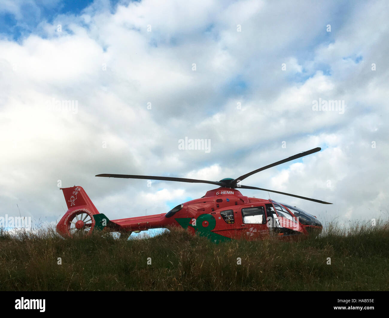 Wales Air Ambulance helicopter landed on top of riverbank to lift off ...
