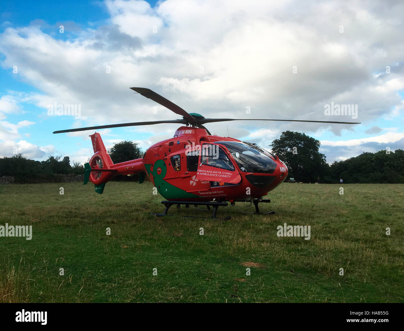 Wales Air Ambulance helicopter landed on top of riverbank to lift off ...
