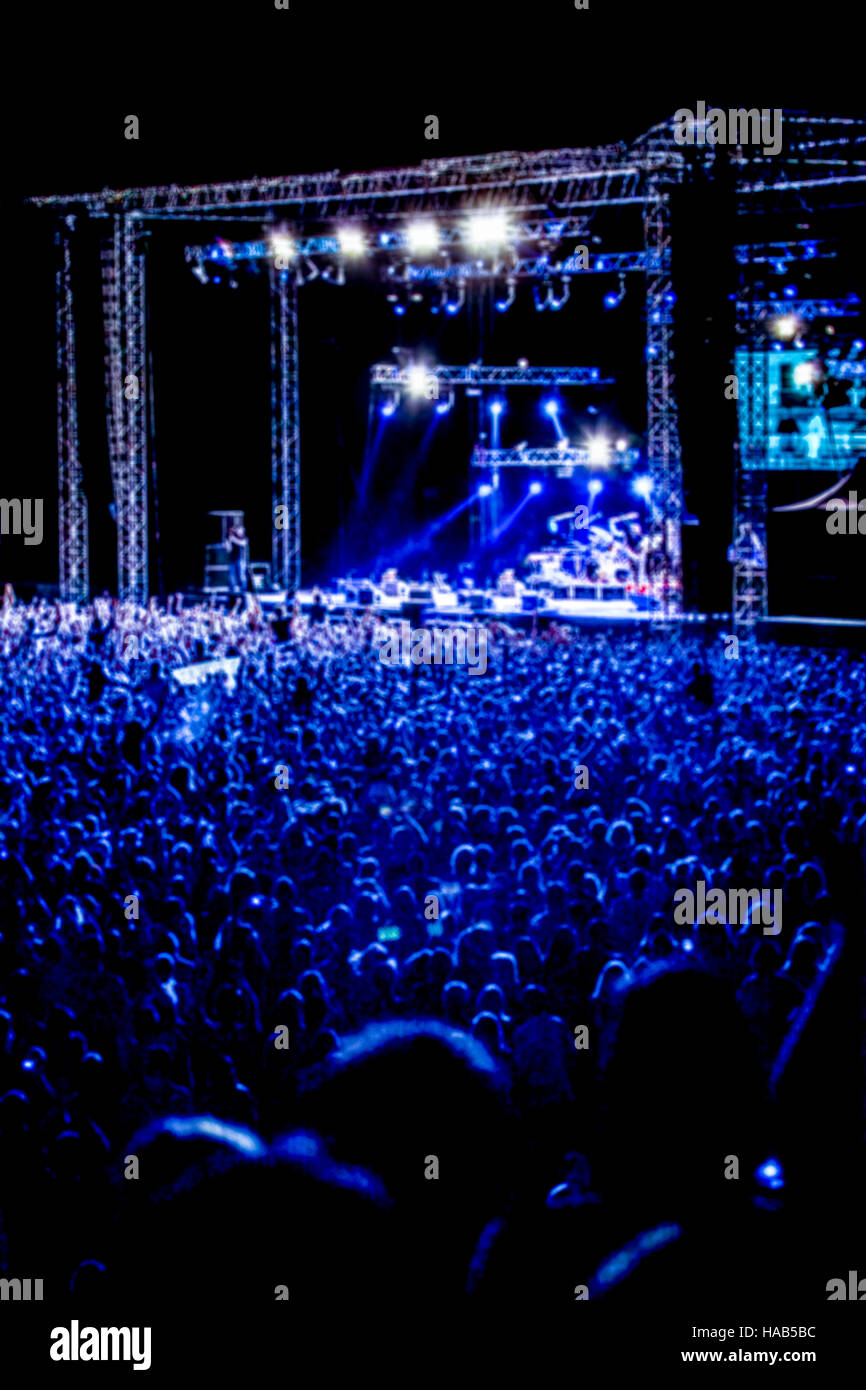 Blurred Image of Huge Crow of People at Music concert, in blue tones ...