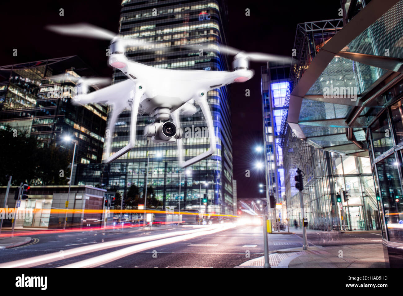 Hovering drone taking pictures of city of London at night Stock Photo ...