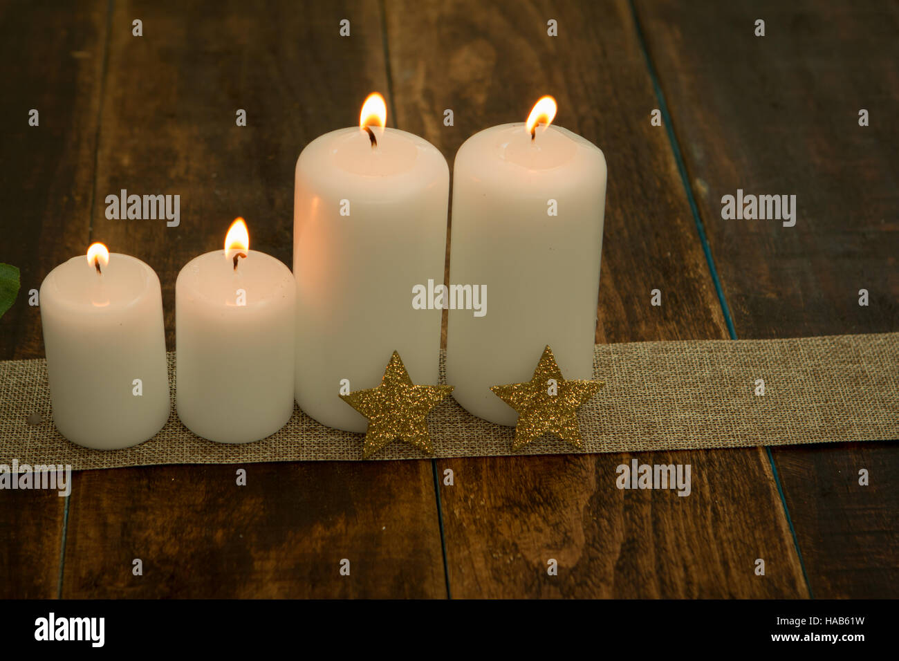 White candles on a rustic wooden background Stock Photo - Alamy