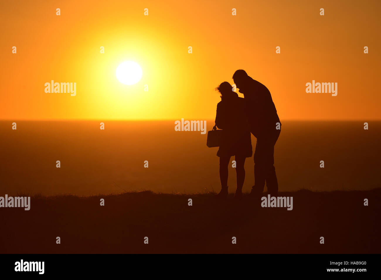 Beachey Head, East Sussex. 28th November 2016. A couple peer over the ...