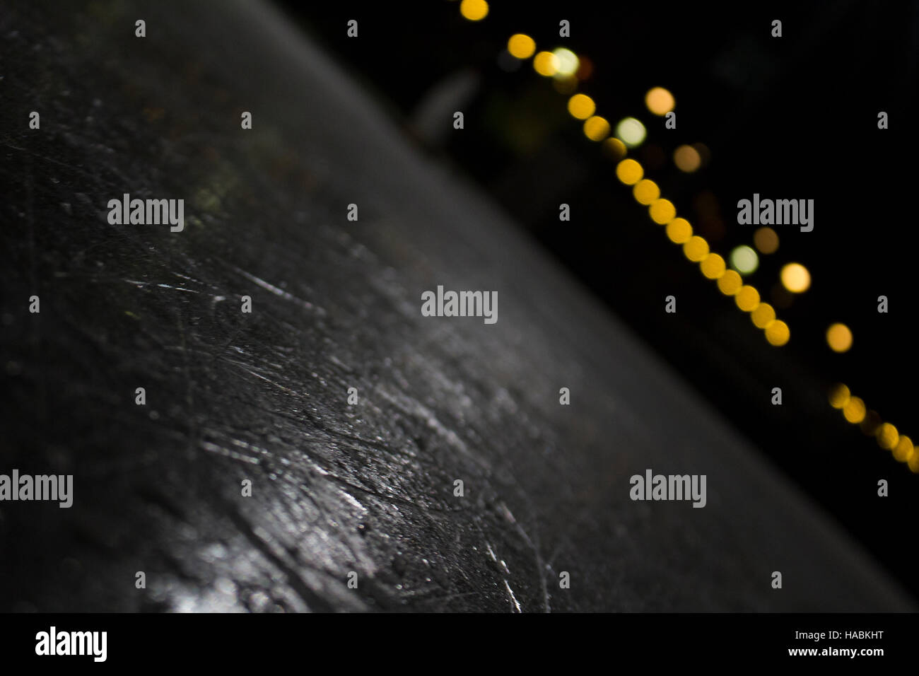 Hard, black, frozen ice with blurry lights in the bakcground Stock ...