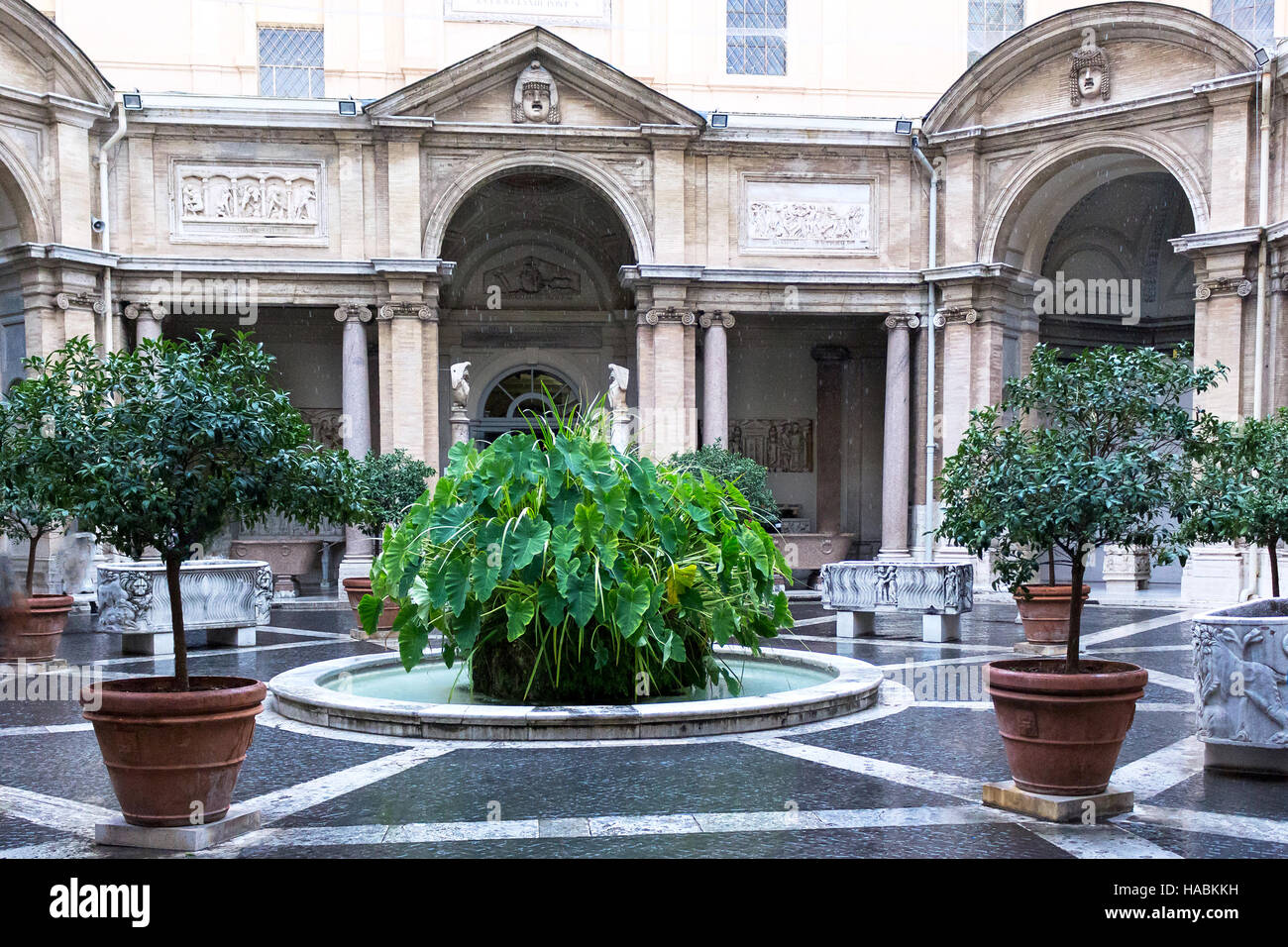 Green plants, rain, and fountain in a building from vatican, rome ...