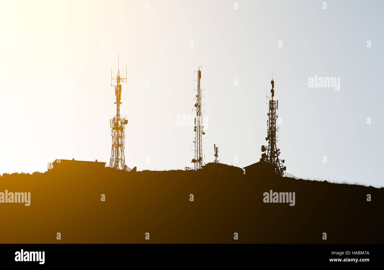 Telecommunication towers with antennas at sunset Stock Photo - Alamy