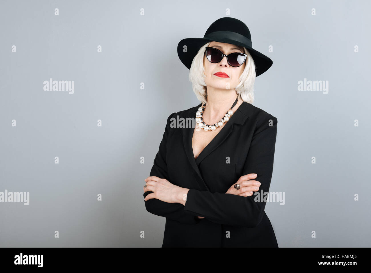 Serious senior woman crossing her arms over chest Stock Photo - Alamy