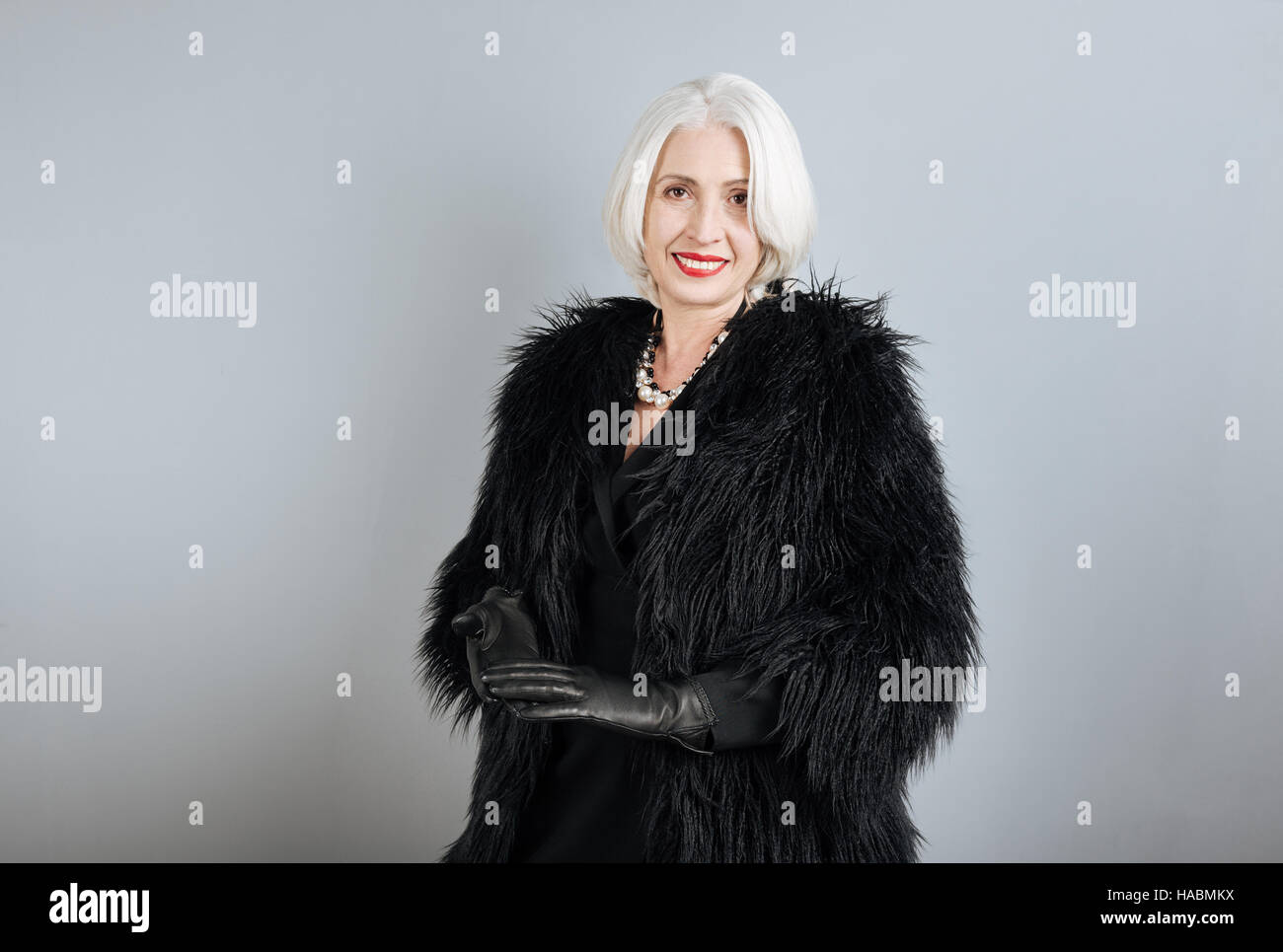 Attractive senior woman standing against isolated background Stock ...