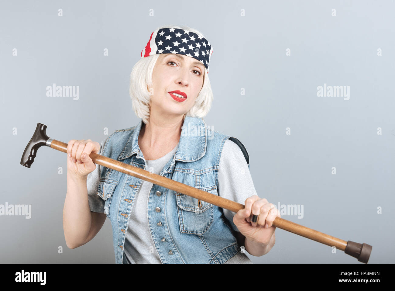 Charming emotional senior lady holding stick Stock Photo - Alamy