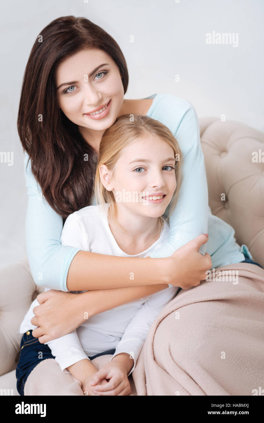 Attractive caring mother hugging her daughter Stock Photo - Alamy