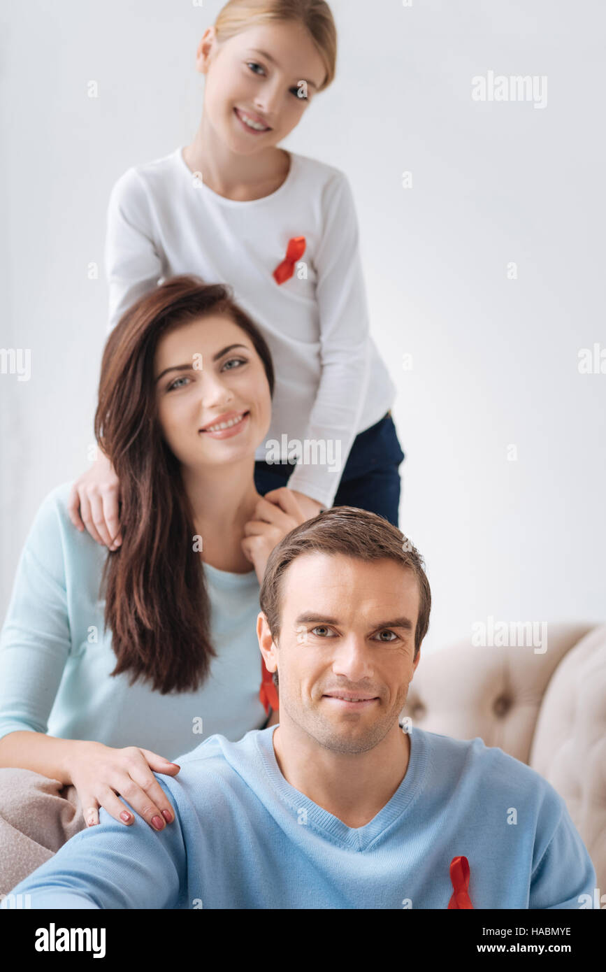 Happy pleasant family supporting AIDS prevention Stock Photo - Alamy