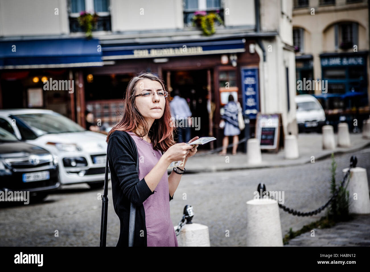 Young lost woman holding city map, Paris, France Stock Photo - Alamy