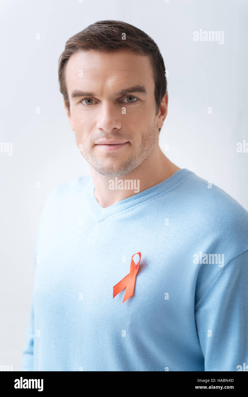 Good looking confident man wearing red AIDS ribbon Stock Photo - Alamy