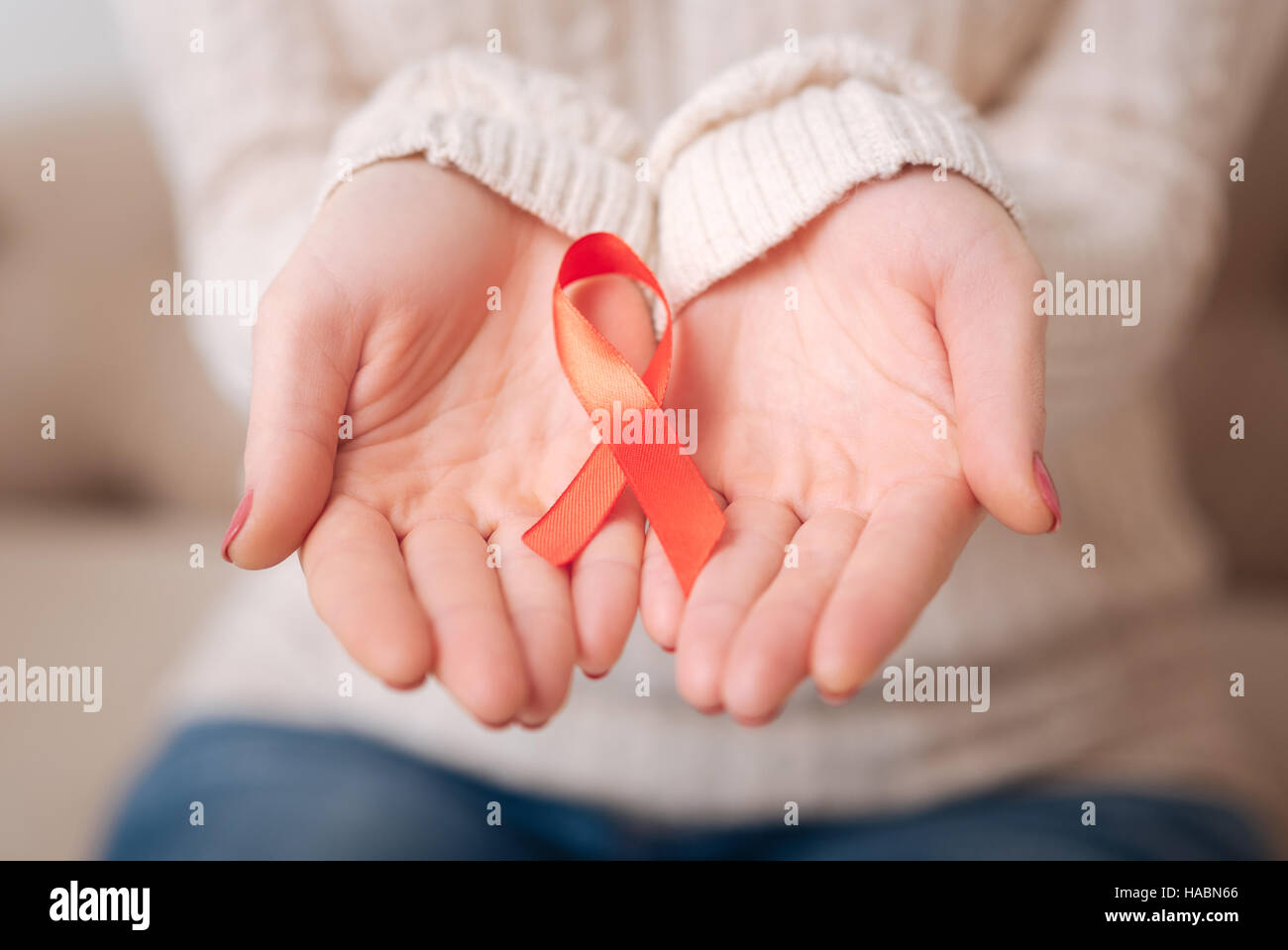 Close up of the AIDS symbol being in womans hands Stock Photo - Alamy