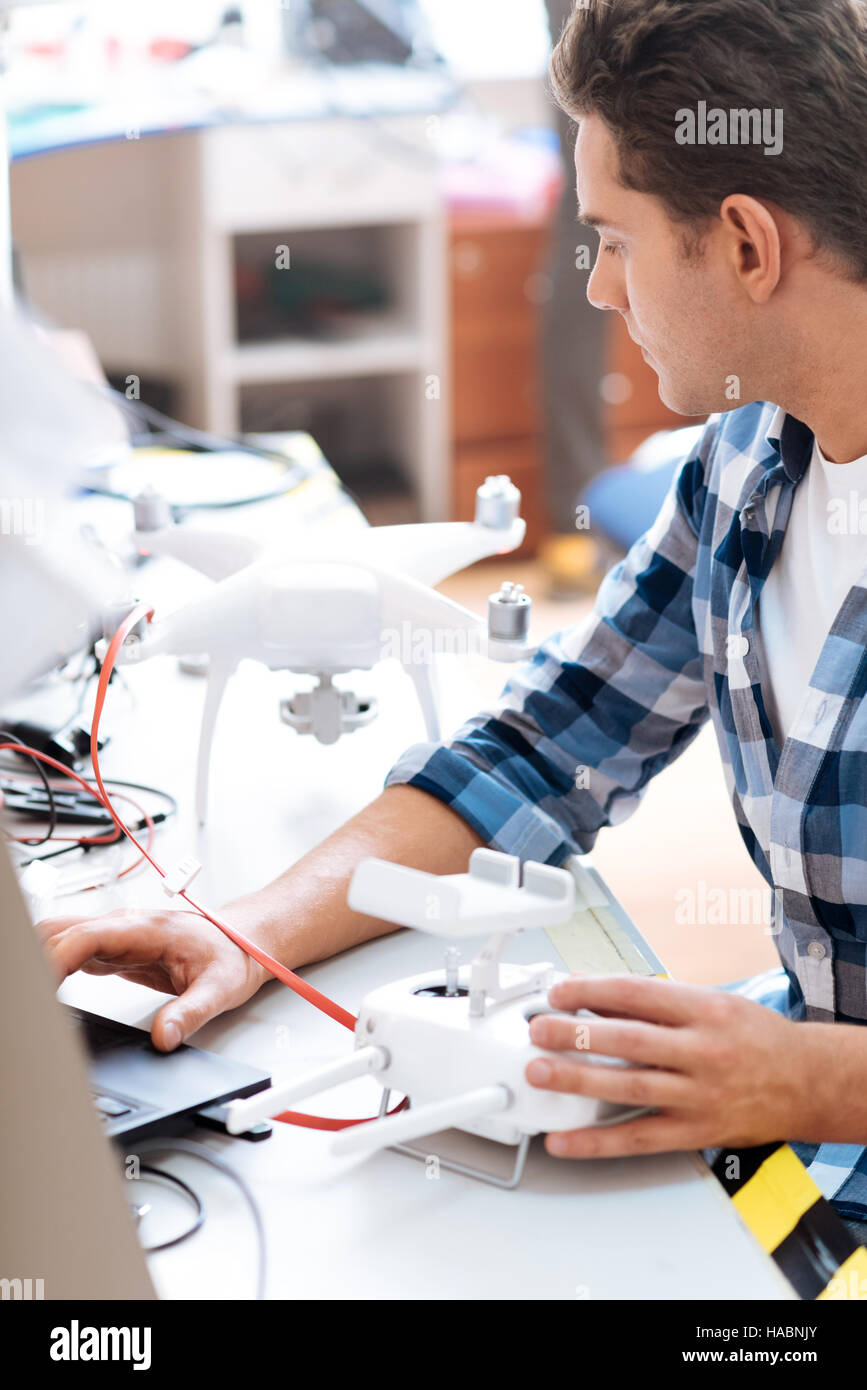 Smart man using laptop and drone remote controller Stock Photo - Alamy