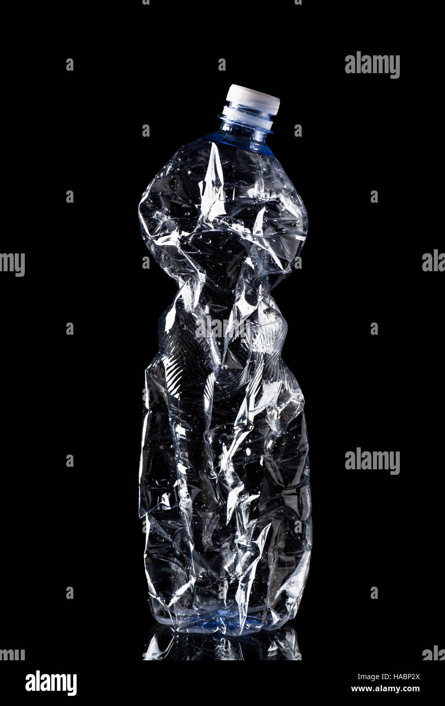 Crumpled Plastic Bottle Isolated on Black Background Stock Photo - Alamy