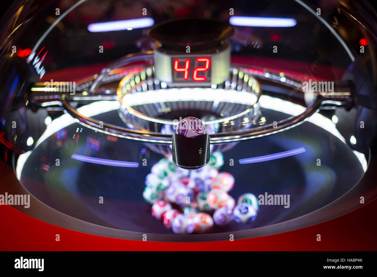 Colourful lottery balls in a lotto machine. Number 42. Gambling machine ...