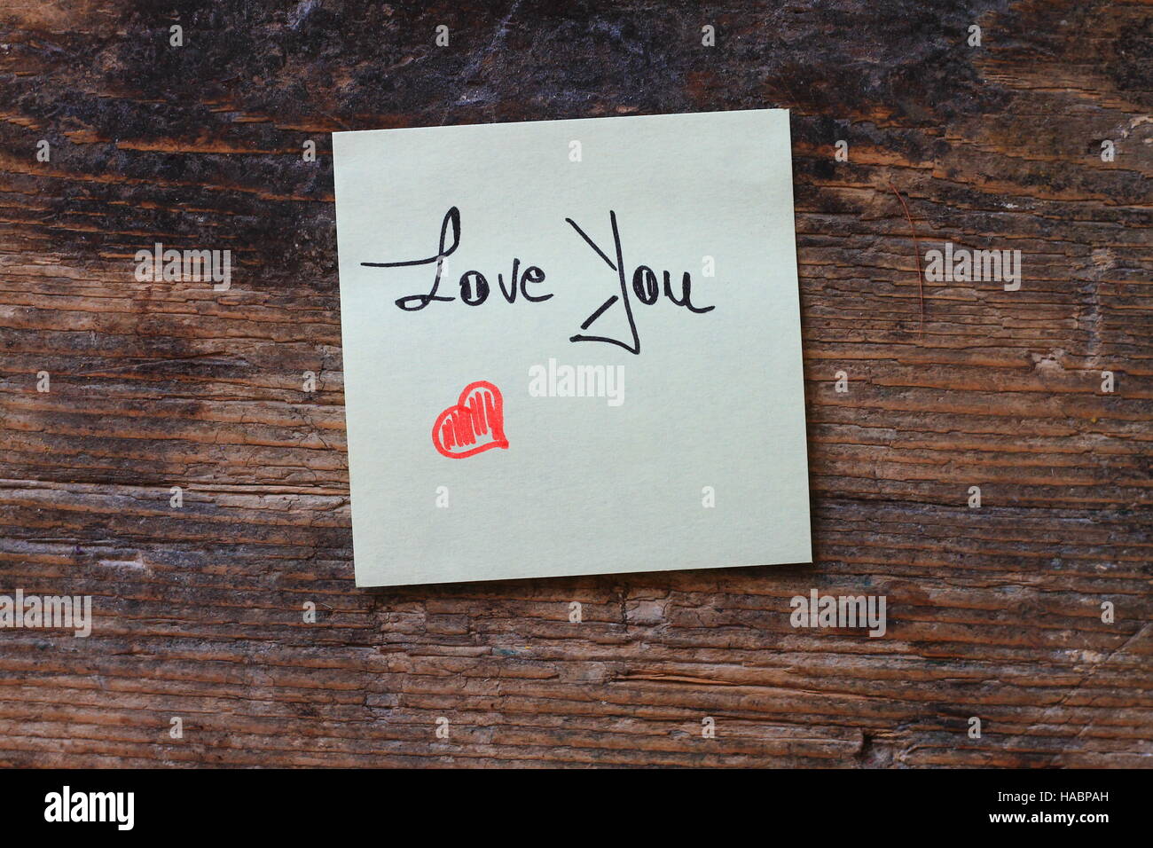 Message Love You with small red heart on wooden table Stock Photo - Alamy