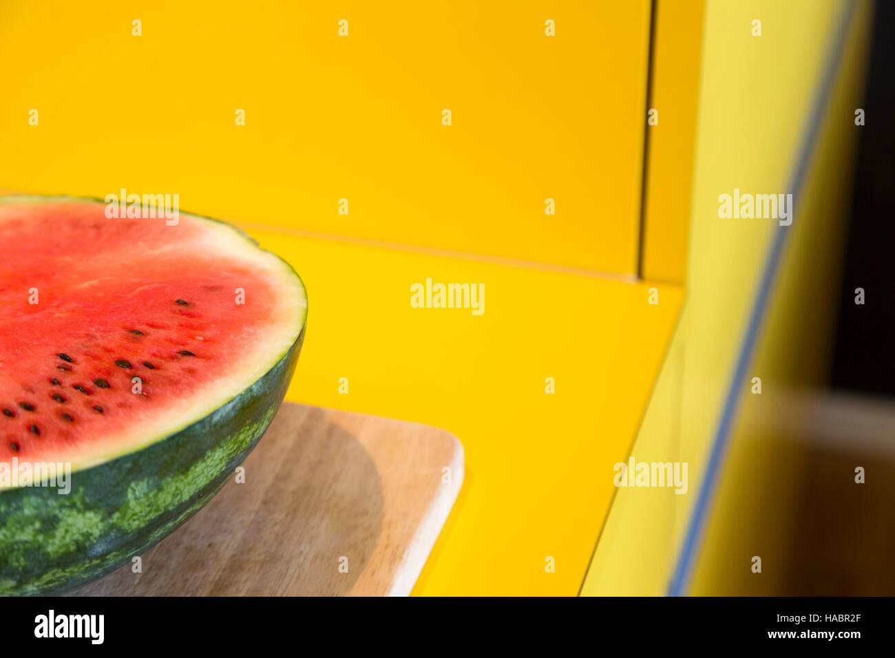 half of a water melon in a yellow kitchen Stock Photo - Alamy