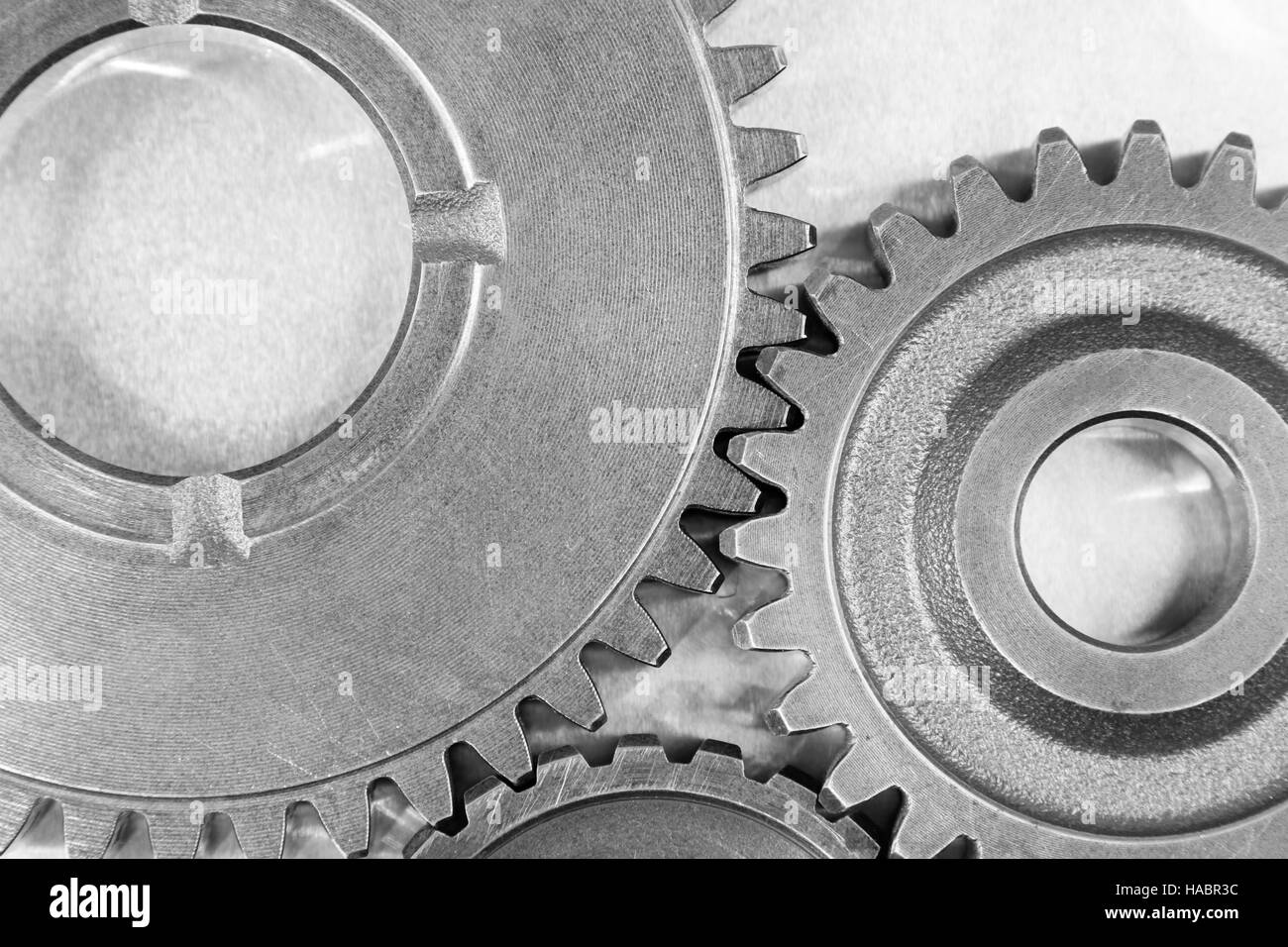 Metal cog gears joining together Stock Photo - Alamy