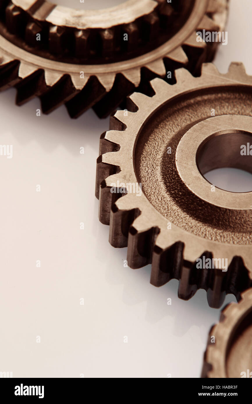 Metal cog gears joining together Stock Photo - Alamy