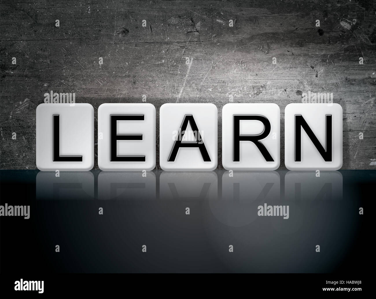 The word "Learn" written in white tiles against a dark vintage grunge ...