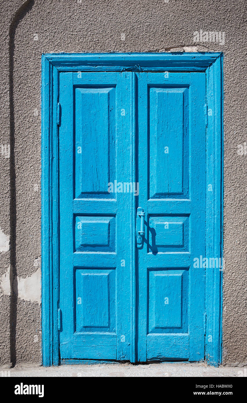 Blue old door on background of gray wall Stock Photo - Alamy