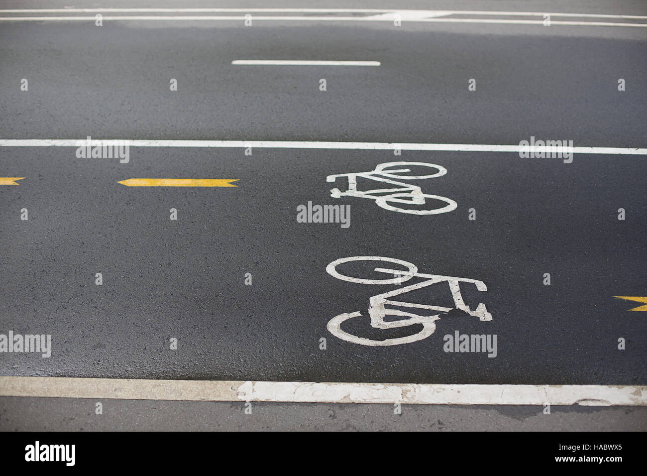 Sign of bicycle lane on wet asphalt Stock Photo - Alamy