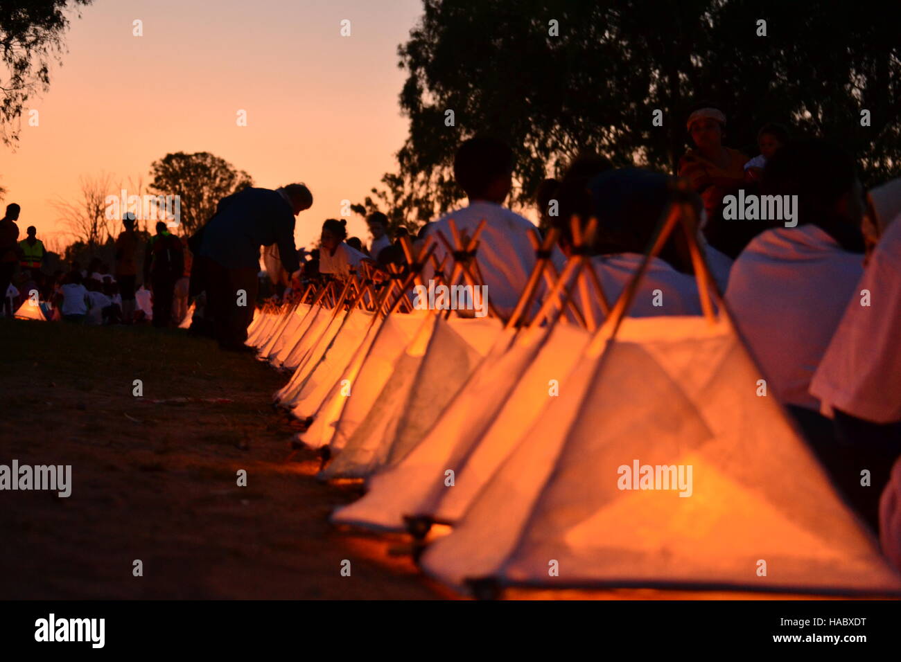 Lighting lanterns at a festival Stock Photo - Alamy