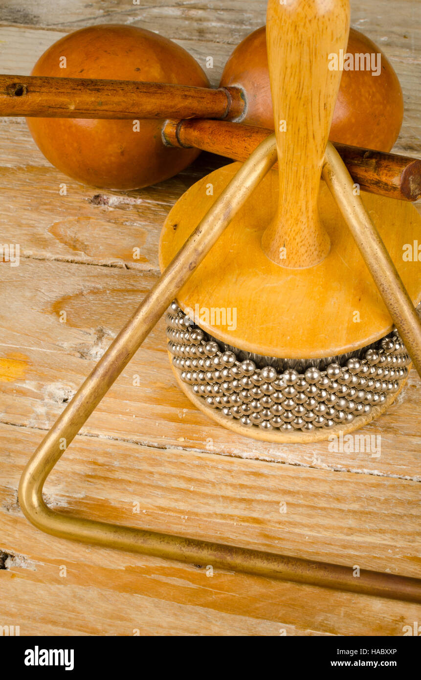 Assorted traditional small percussion instruments on a wooden ...