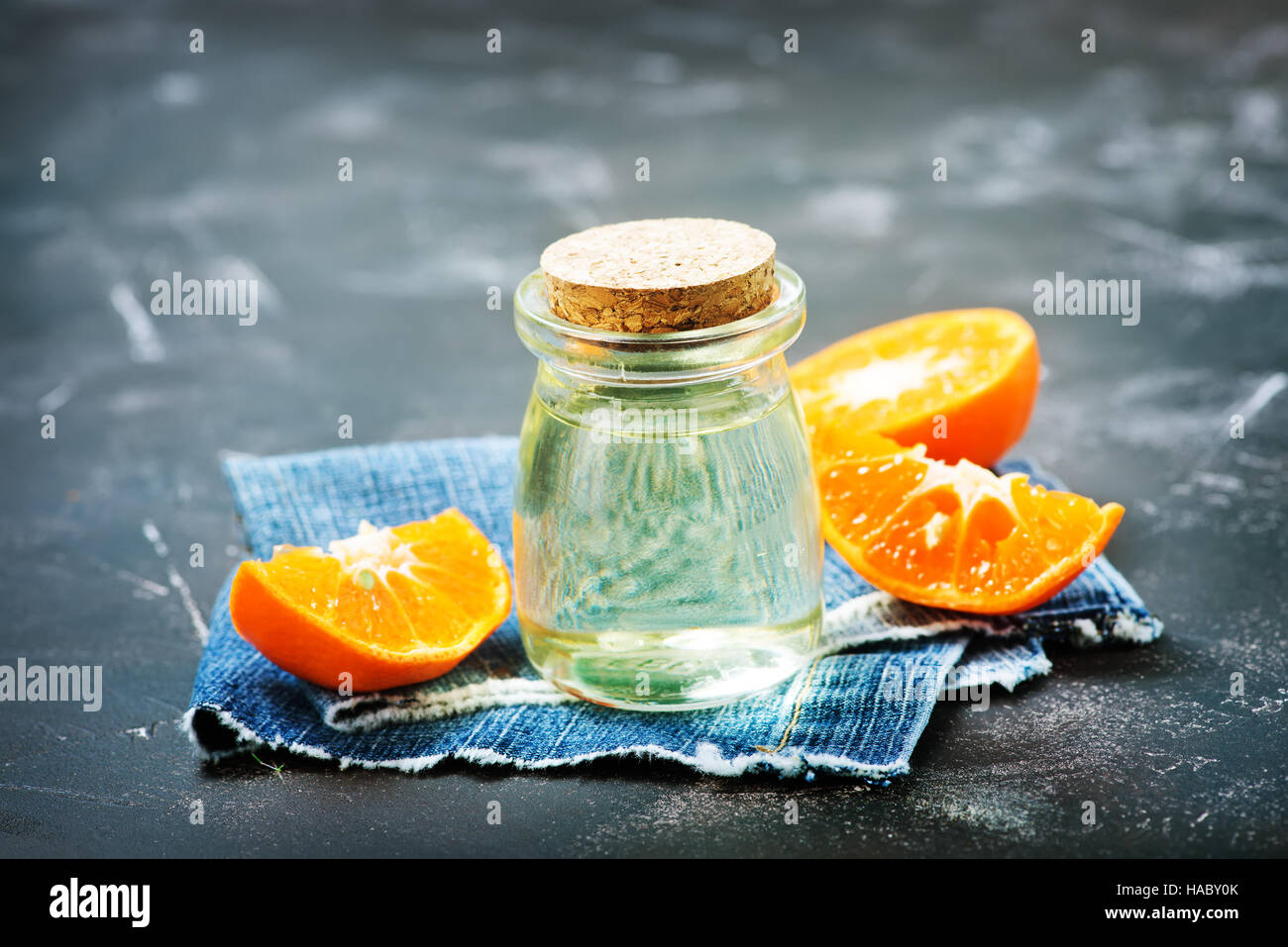 orange oil in glass bottle and on a table Stock Photo - Alamy