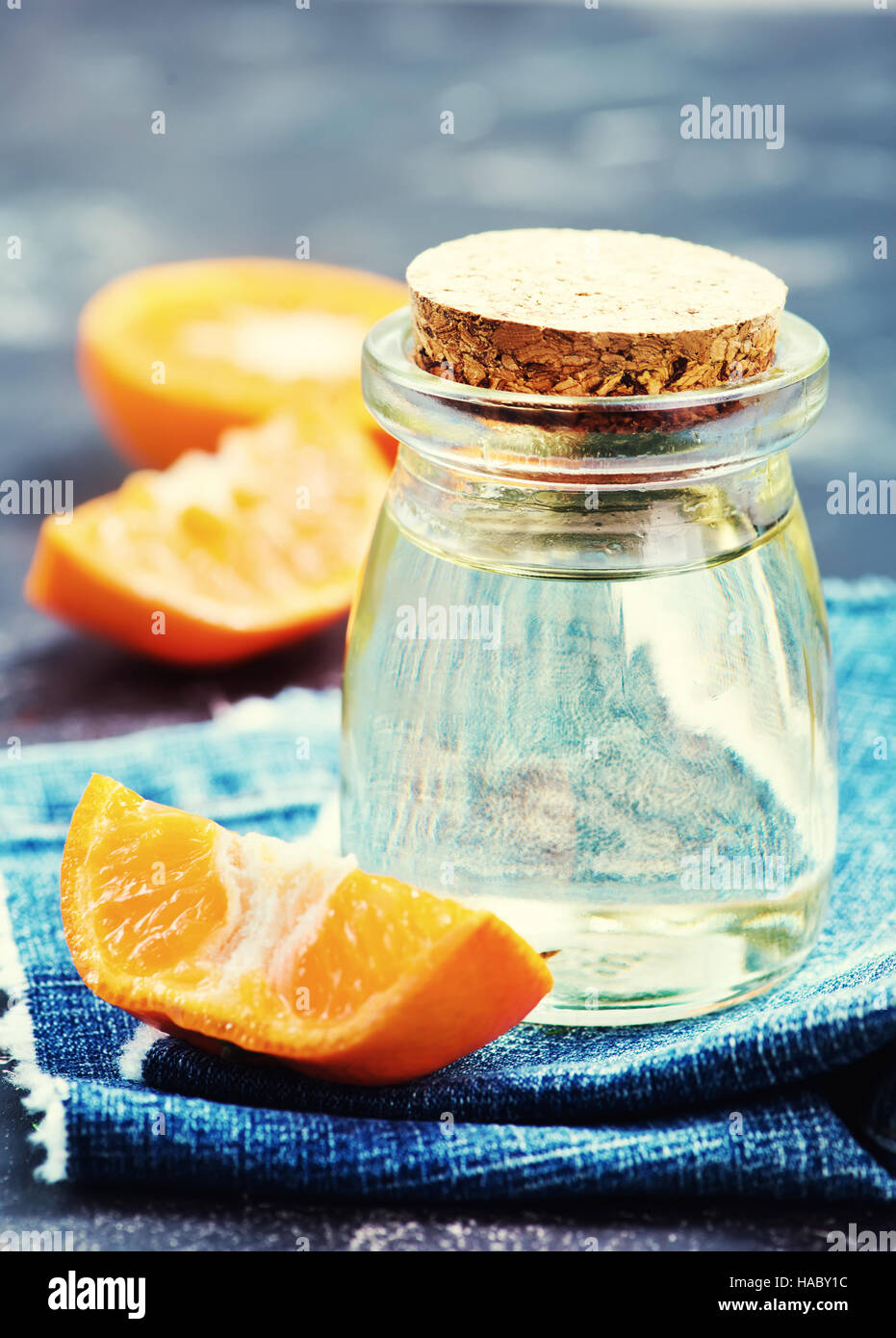 orange oil in glass bottle and on a table Stock Photo - Alamy