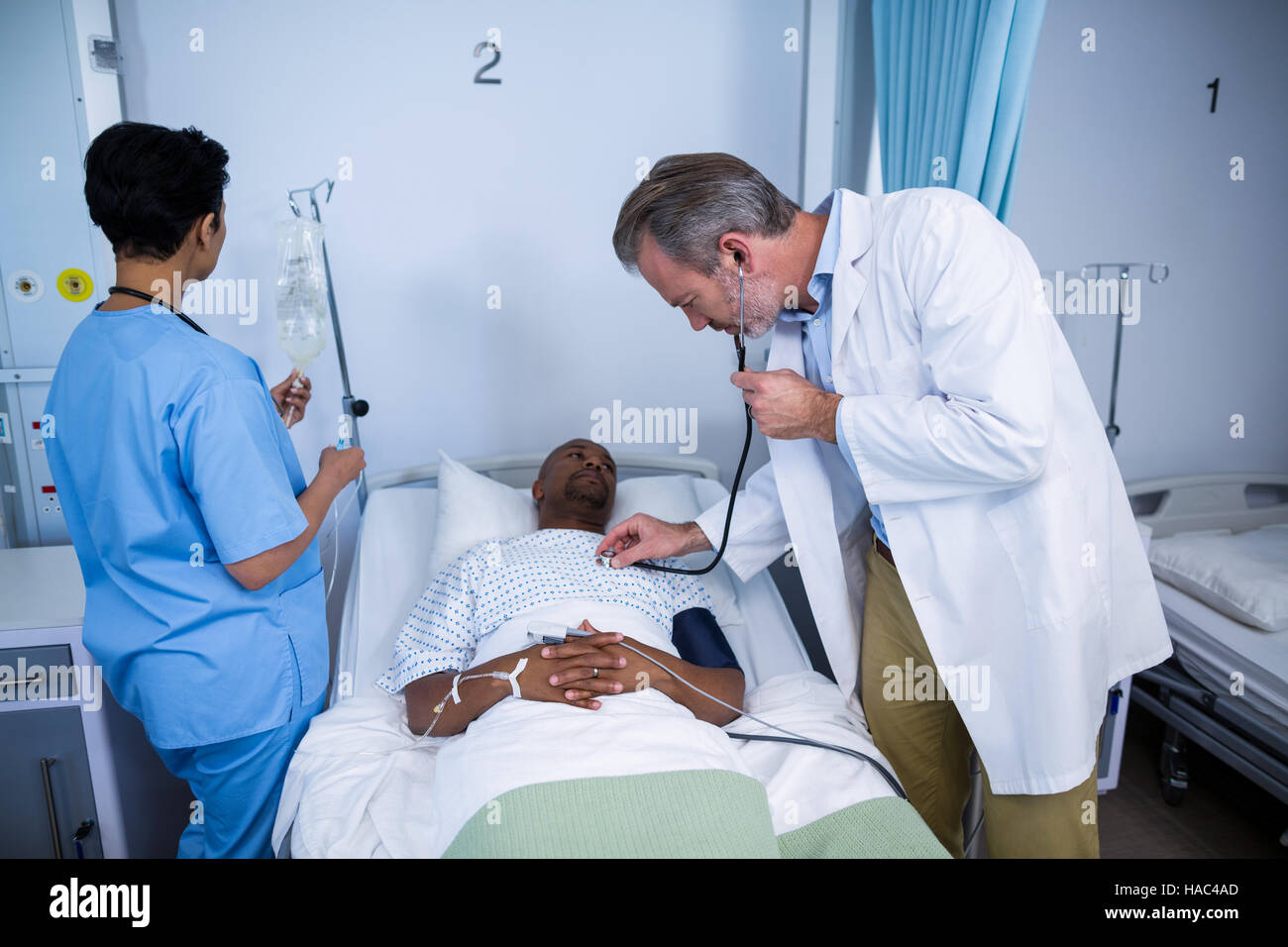 Doctor checking heartbeat patient in hi-res stock photography and ...