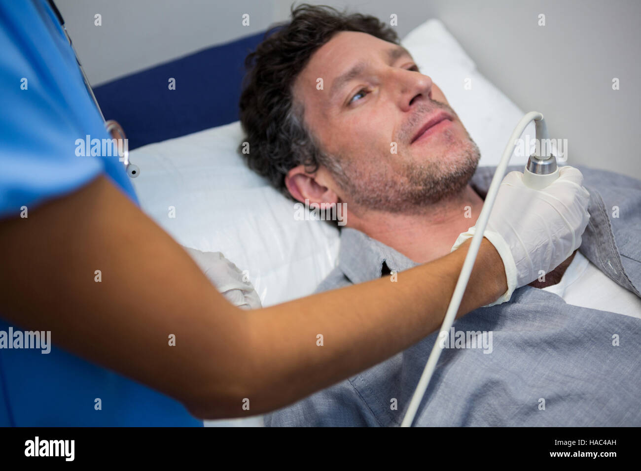 Doctors performing a doppler sonography on patient Stock Photo - Alamy