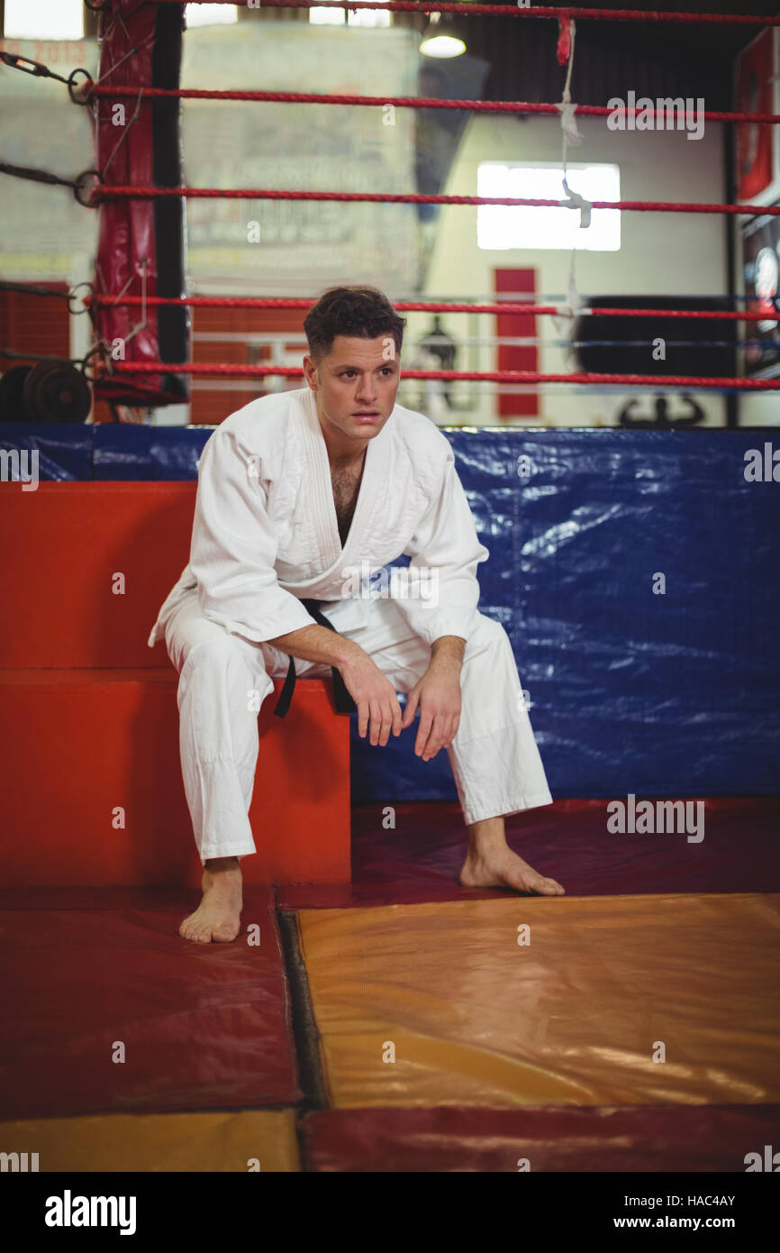 Karate player sitting in fitness studio Stock Photo - Alamy