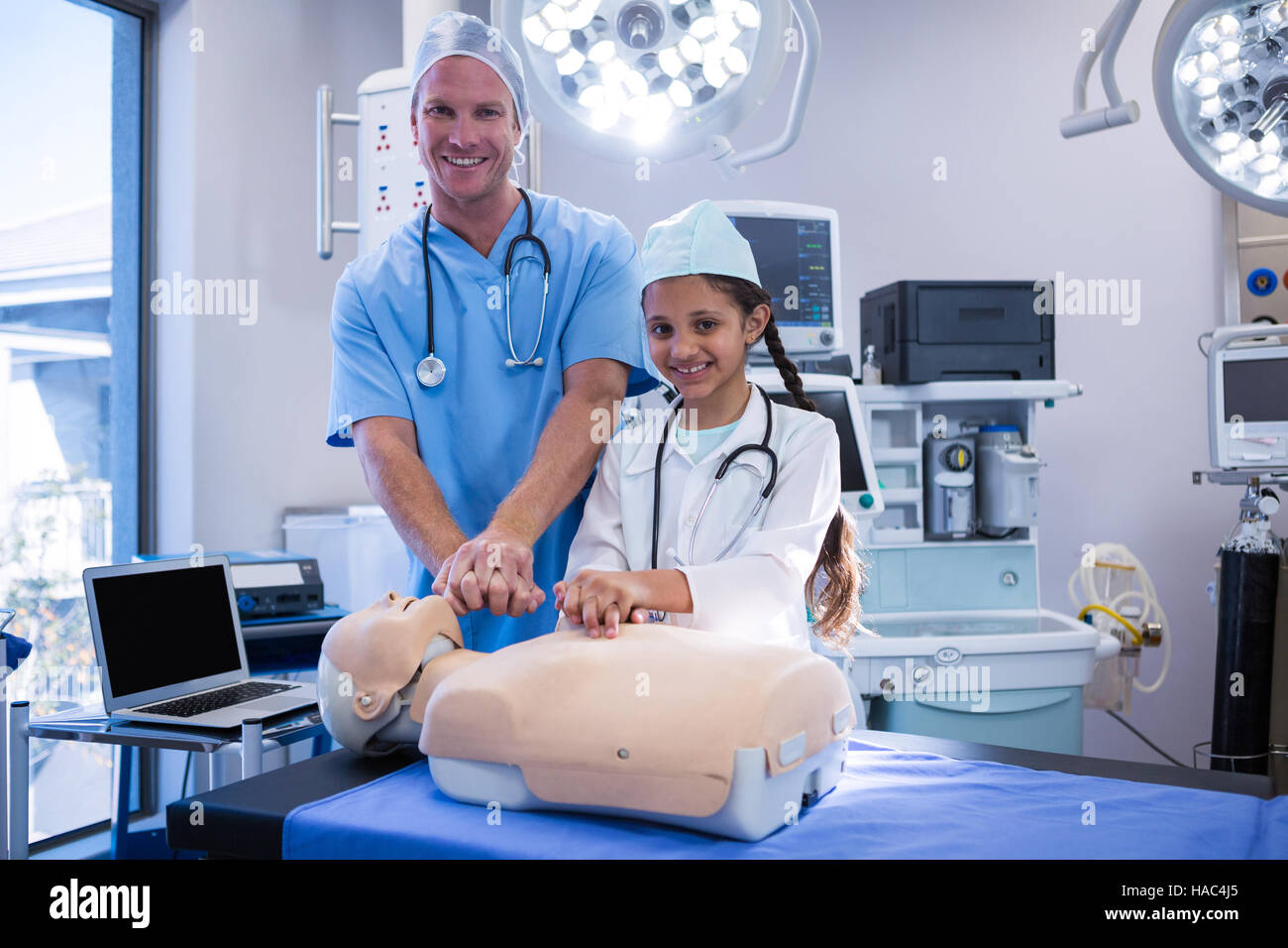 Portrait of doctor and girl examining a dummy Stock Photo - Alamy
