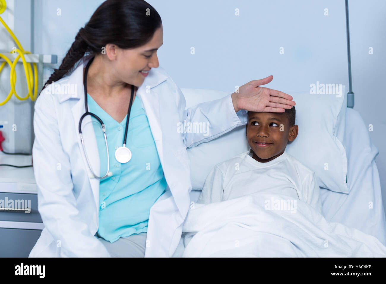 Female doctor checking fever of patient Stock Photo - Alamy