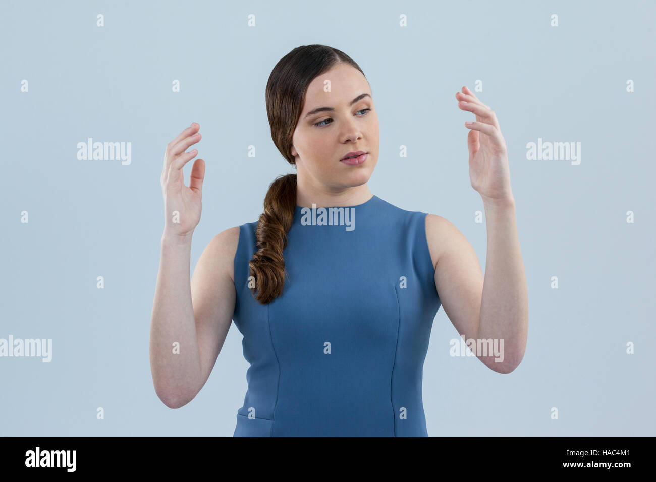 Beautiful woman looking at her hand gestures Stock Photo - Alamy