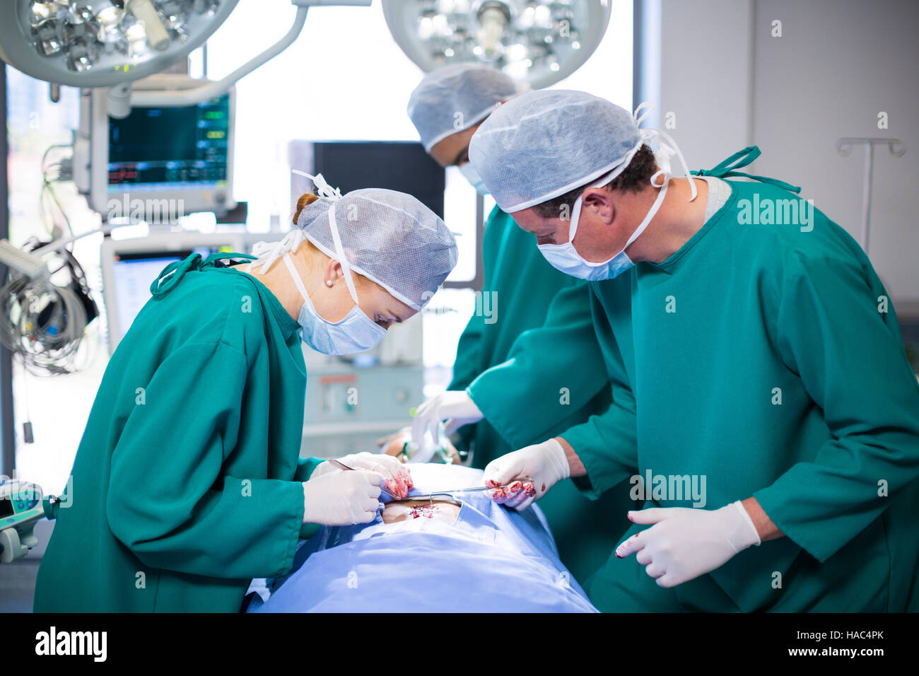 Surgeons performing operation in operation theater Stock Photo - Alamy